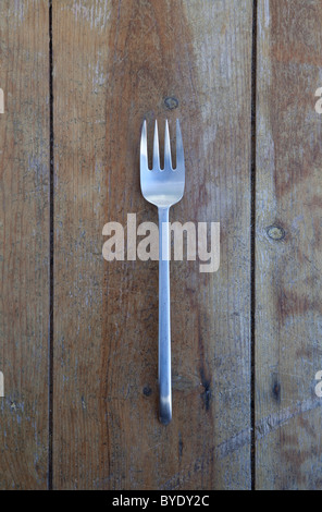 From above shot of fork lying on ceramic bowl full of tasty purple ...