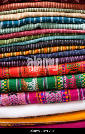 A pile of traditional Andes textiles in the local sunday market of ...