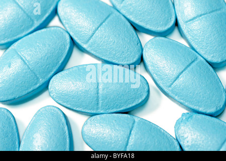 Light blue pills close up triangle macro photography drug on white ...