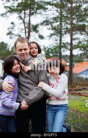 Daddy hugs his daughters Stock Photo - Alamy