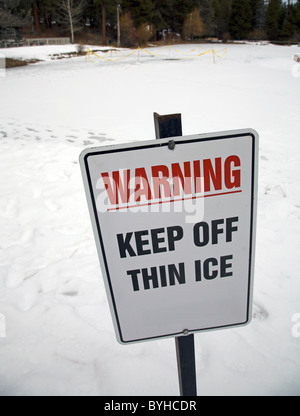 Danger Thin Ice warning signs beside a frozen lake, Fleet Pond ...