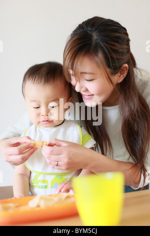 Boy feeding bread to his mother Stock Photo - Alamy