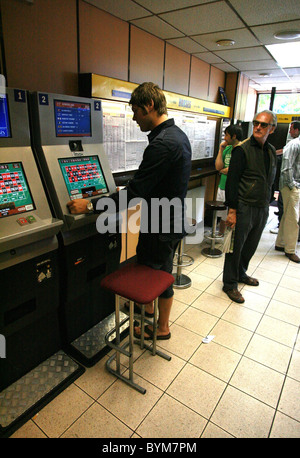 Brian McFadden placing a bet in a bookmakers in Primrose Hill London ...
