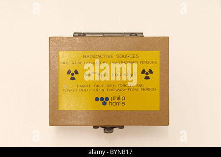 A sealed radioactive cup source (Americium 241 or Am-241) being removed ...