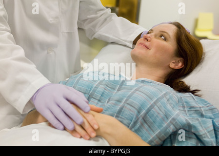 Sympathetic doctor comforting a female patient Stock Photo - Alamy
