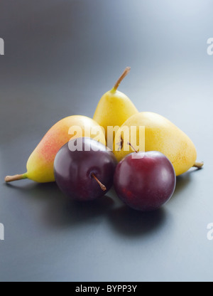 Two juicy bright yellow plums dipped in focus close-up, on a white ...