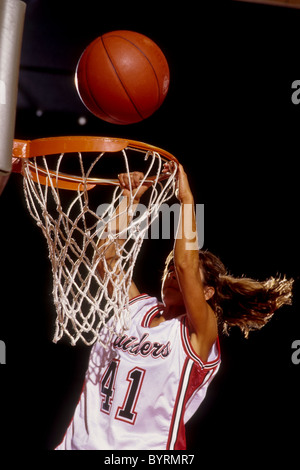 Female basketball player slam dunking Stock Photo - Alamy