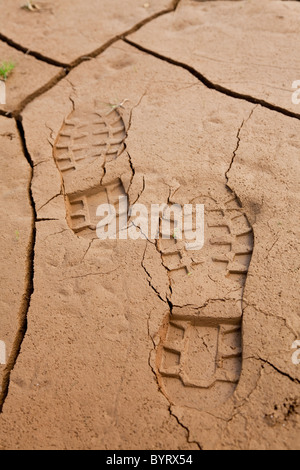 Boot footprints in the mud Stock Photo - Alamy