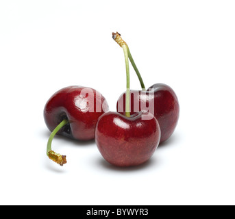 Isolated cherries. One whole cherry fruit and one cut in half with ...