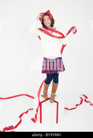 Young woman wrapping ribbons around her body Stock Photo - Alamy