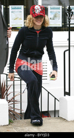 Madonna looking happy as she leaves her gym, wearing a red and black ...