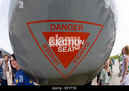 Closeup of Warning Ejection Seat Sign on side of aircraft fuselage ...