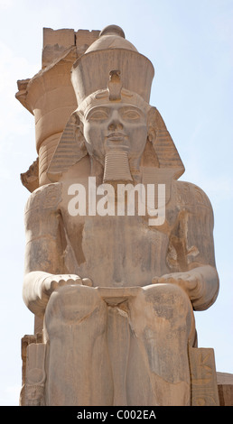 Large statues of Ramses II in ancient egyptian Medinat Habu Temple with ...