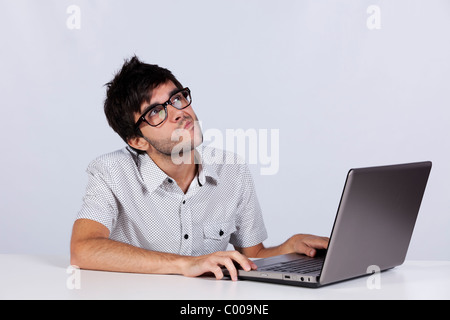 Funny crazy looking nerd in thick lens glasses sitting in office and ...