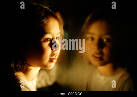 Girl at night with window reflection Stock Photo - Alamy