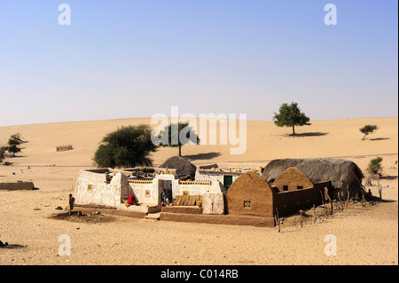 Traditional farmhouse with a painted exterior walls and twig roof in ...