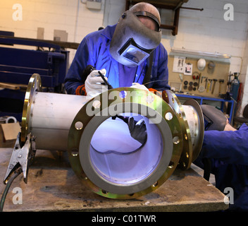 Two welders working together on a difficult metal work project ...