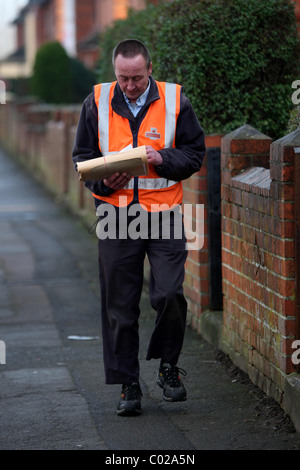 Postman working for An Post delivering letters on a push bike in ...