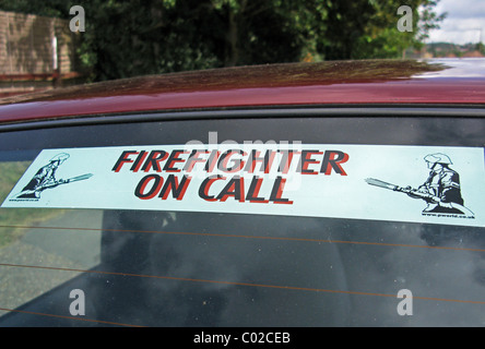 Firefighter On Call sign on a car widow Stock Photo - Alamy