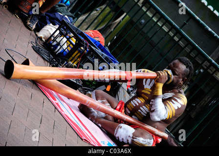 Aboriginal man playing a didgeridoo on a beach Stock Photo - Alamy