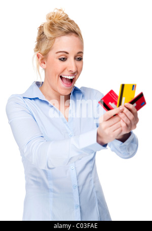 Surprised young woman with credit cards and shopping bags on red ...