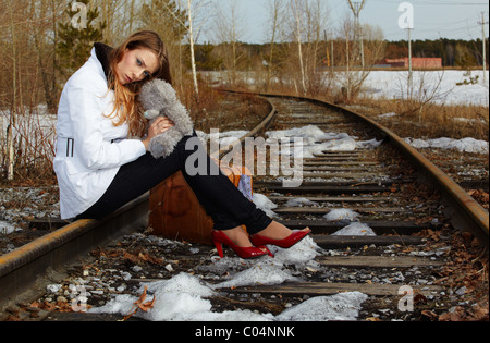 Blonde girl sitting on rail Stock Photo: 25758973 - Alamy
