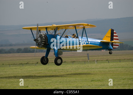 Biplane landing on the grass Stock Photo - Alamy