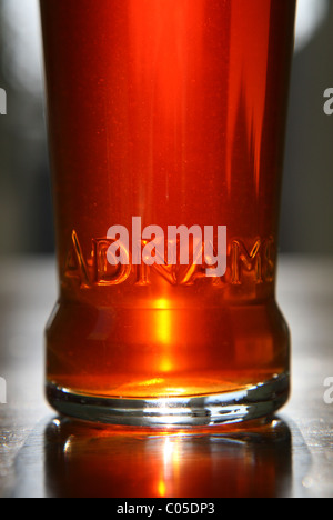 A pint of Adnams beer in an Adnams glass Stock Photo - Alamy