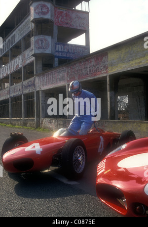 Race car driver Phil Hill, of Santa Monica, Calif., center, is all ...