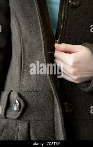 Hand zipping up jacket Stock Photo - Alamy