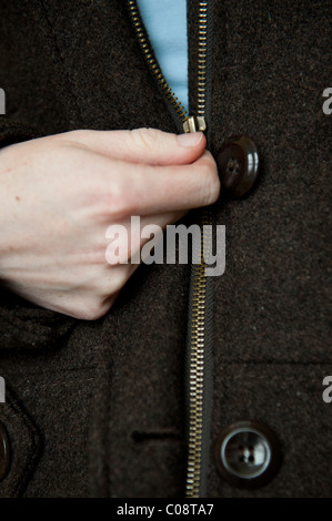 Hand zipping up jacket Stock Photo - Alamy
