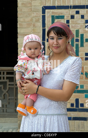 Portrait of an Uzbeki mother and child in the courtyard of the Kalon ...