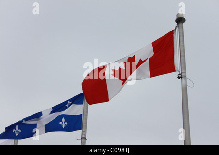 Quebec, Canadian and Montreal flags waving with the foreground of City ...