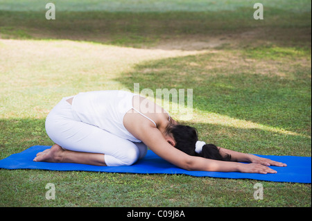 Woman doing Shashankasana pose (Hare Pose Stock Photo - Alamy