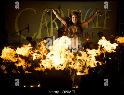A person performs fire dancing with flames creating a fiery spiral ...