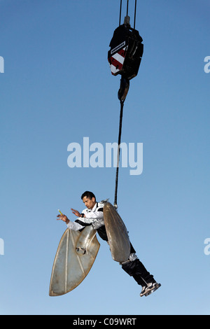 Man with wings hanging on a rope, floating in the air, Global Rheingold ...