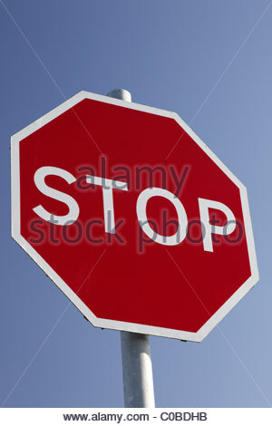 Octagonal red stop sign at a UK road junction Stock Photo - Alamy