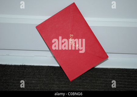 An envelope with SWALK Sealed With A Loving Kiss on the back and a pair ...