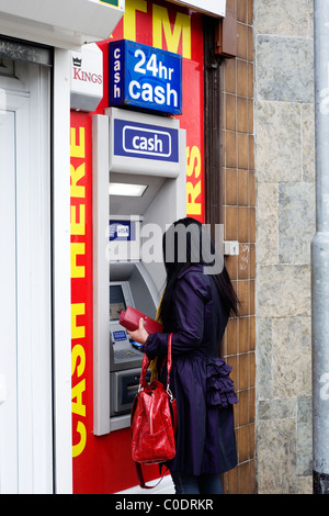 Woman at 24 hour ATM machine NM Stock Photo - Alamy
