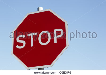 British traffic signs. A red octagonal stop sign beside a country Stock ...
