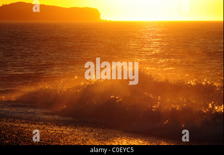 Sunset on the sea with the waves Stock Photo - Alamy