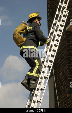 Fireman climbing a ladder Stock Photo - Alamy