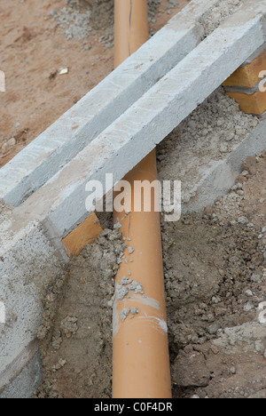 A concrete lintel placed over the new mains drain pipe Stock Photo - Alamy
