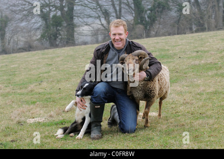 Adam Henson Cotswold farmer with his dog and a rare breeds Soay Ram on Adam's farm. BBC ...