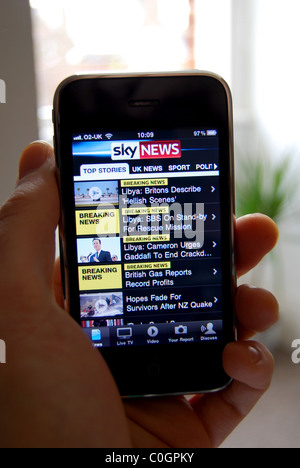 Photo illustration of an iphone 3gs showing the sky news app on display ...