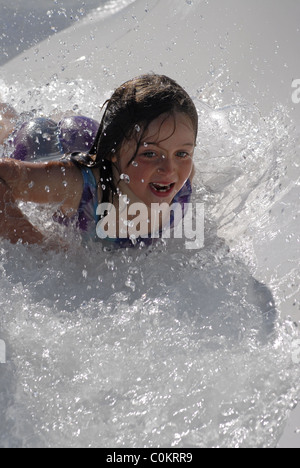 Little girl sliding down head first Stock Photo - Alamy