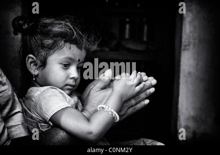 Folded hands resting on a lap Stock Photo - Alamy