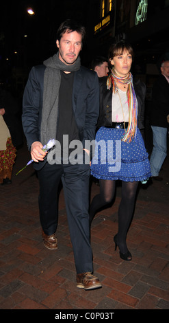 Keanu Reeves holding a single white rose leaves the Empire Casino with ...