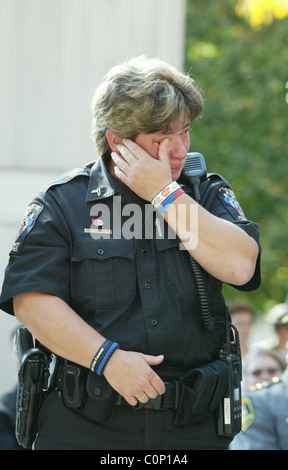 The bereaved hold their rose before placing on the National Law ...