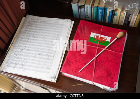 Welsh conductor's baton on file of manuscripts with red dragon flag ...